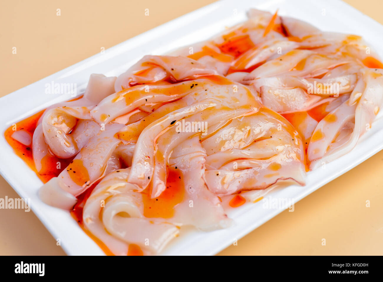 Fresh squid meat sliced and arranged in square dish Stock Photo - Alamy