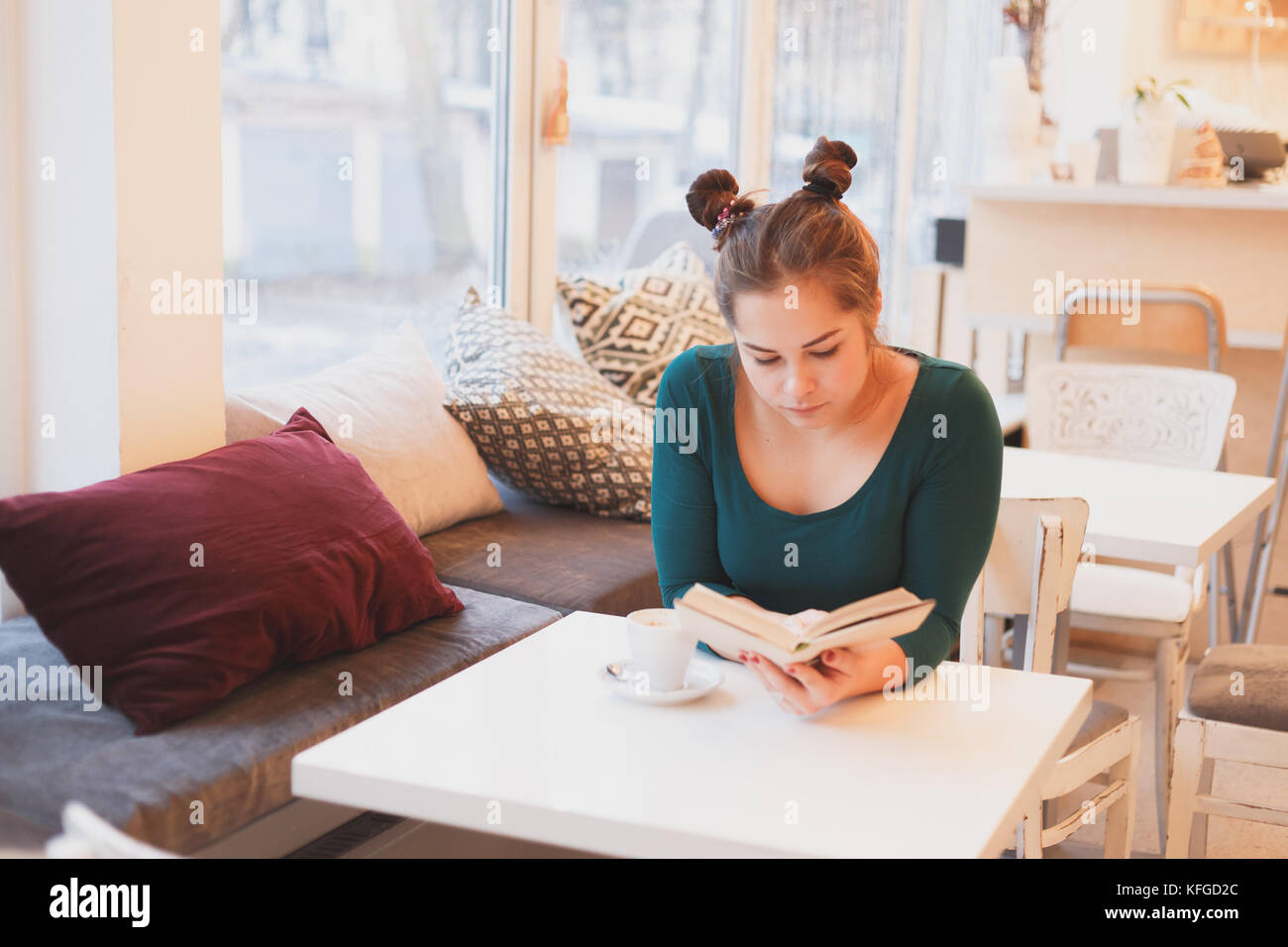 Side view portrait of attractive young girl enjoying a good book ...