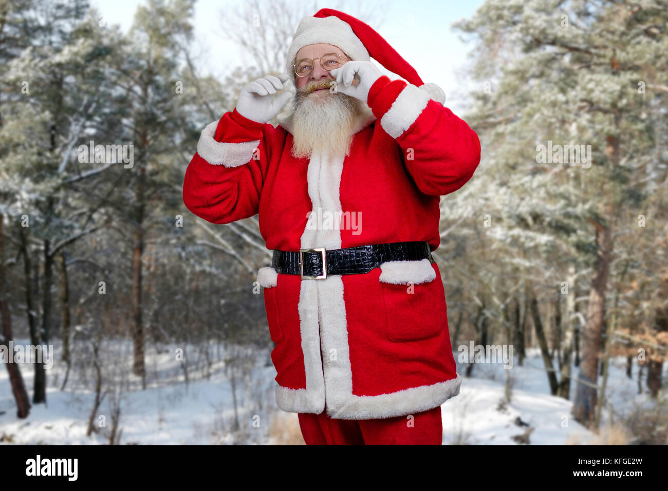Santa Claus touching his mustache. Happy Santa Claus touching his real ...