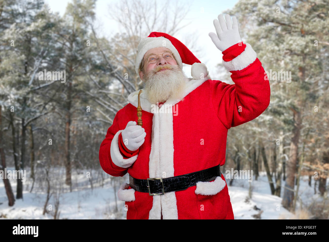 Santa waving with hands outdoors. Santa Claus looking upwards with ...
