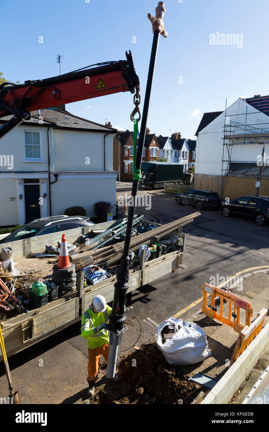 Team of lighting contractors fitting a Heritage street lamp / street ...