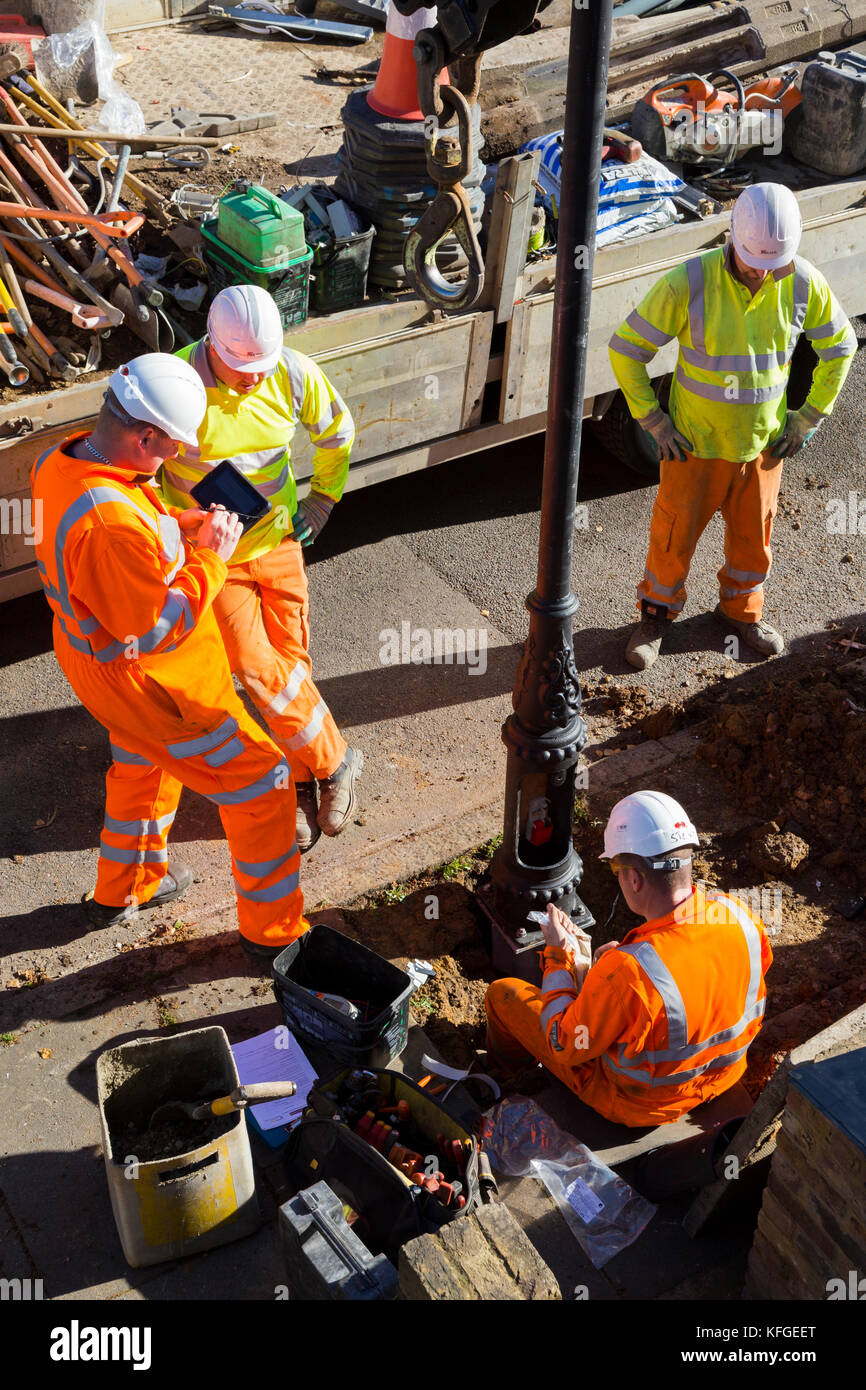 Team of lighting contractors fitting a Heritage street lamp / street ...