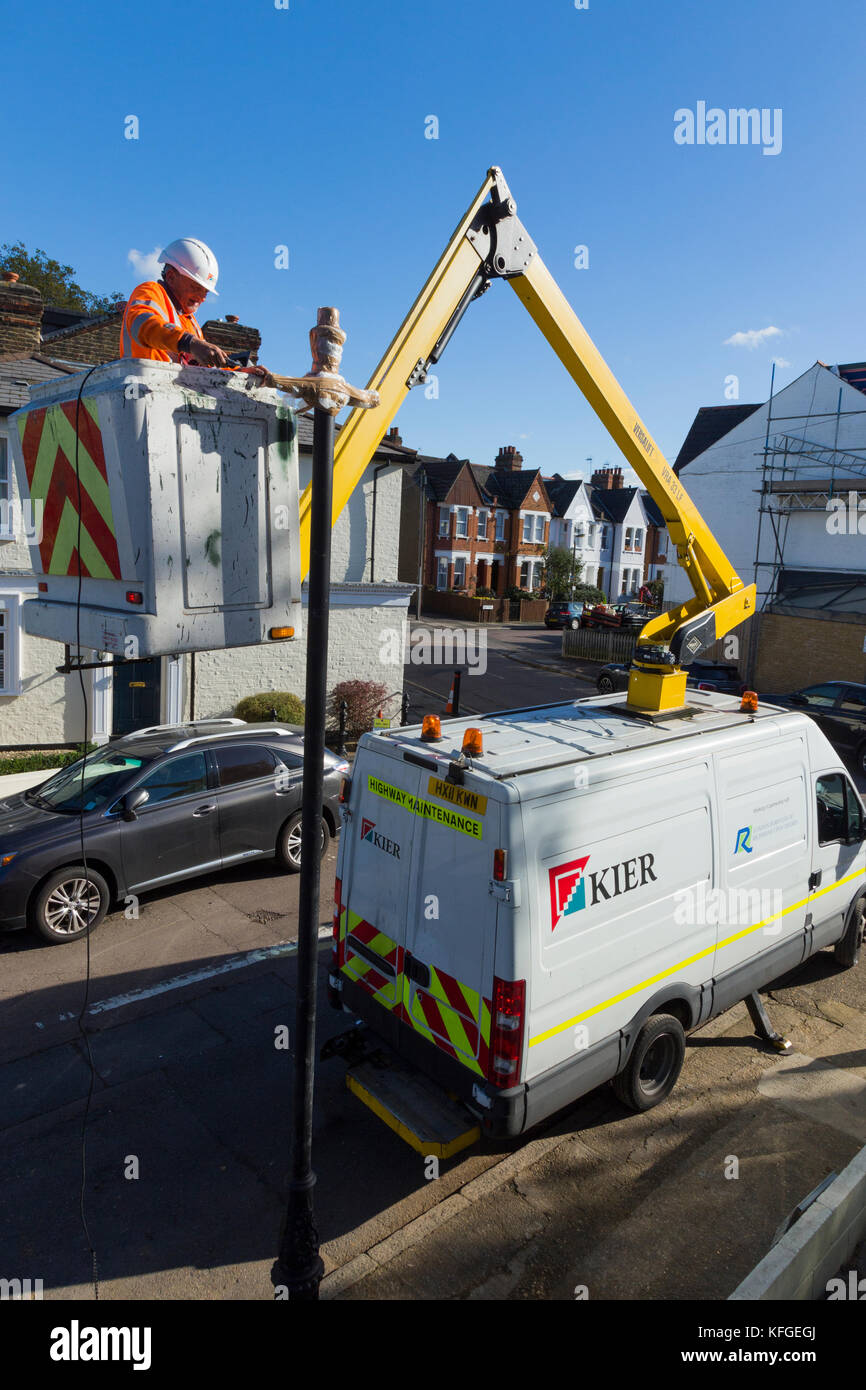 Team of lighting contractors fitting a Heritage street lamp / street ...
