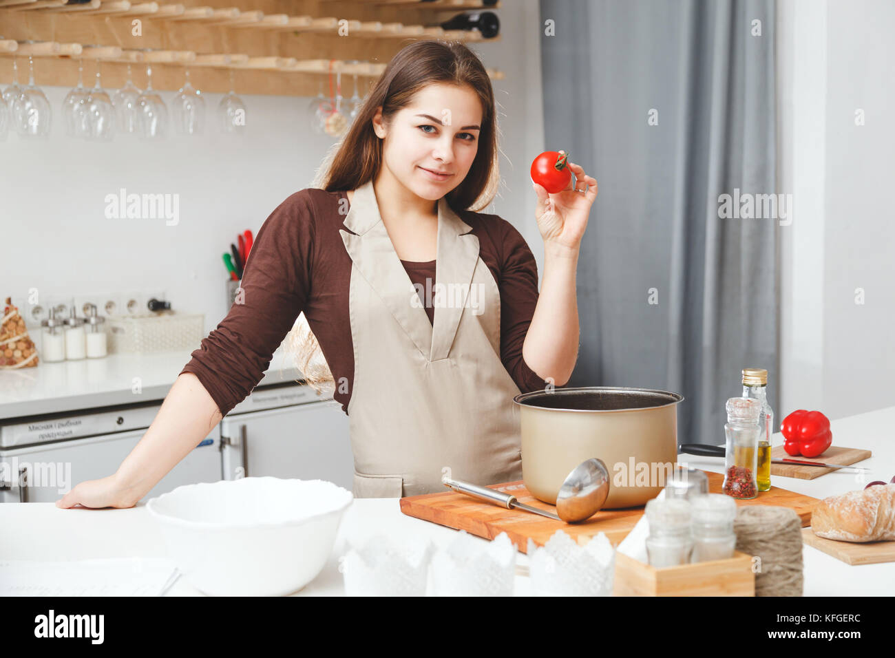 Healthy eating. Girl with tomato in hand, going to cook tomato soup ...