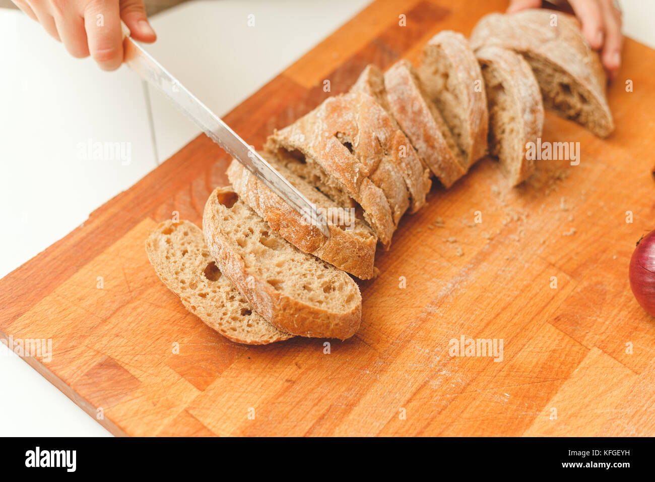 Person slicing fresh bread hi-res stock photography and images - Alamy