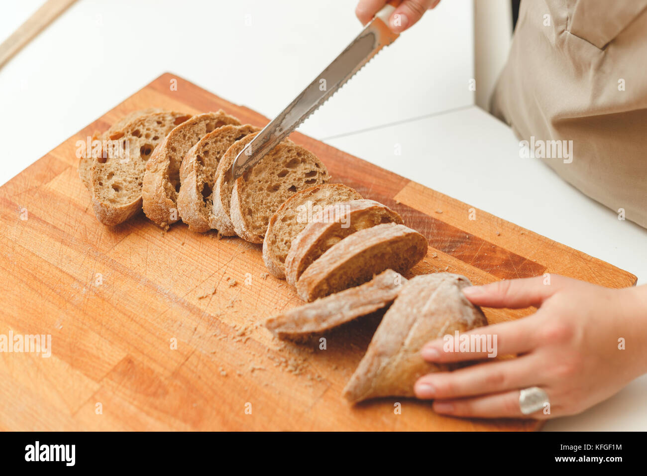 Hand cutting bread hi-res stock photography and images - Alamy