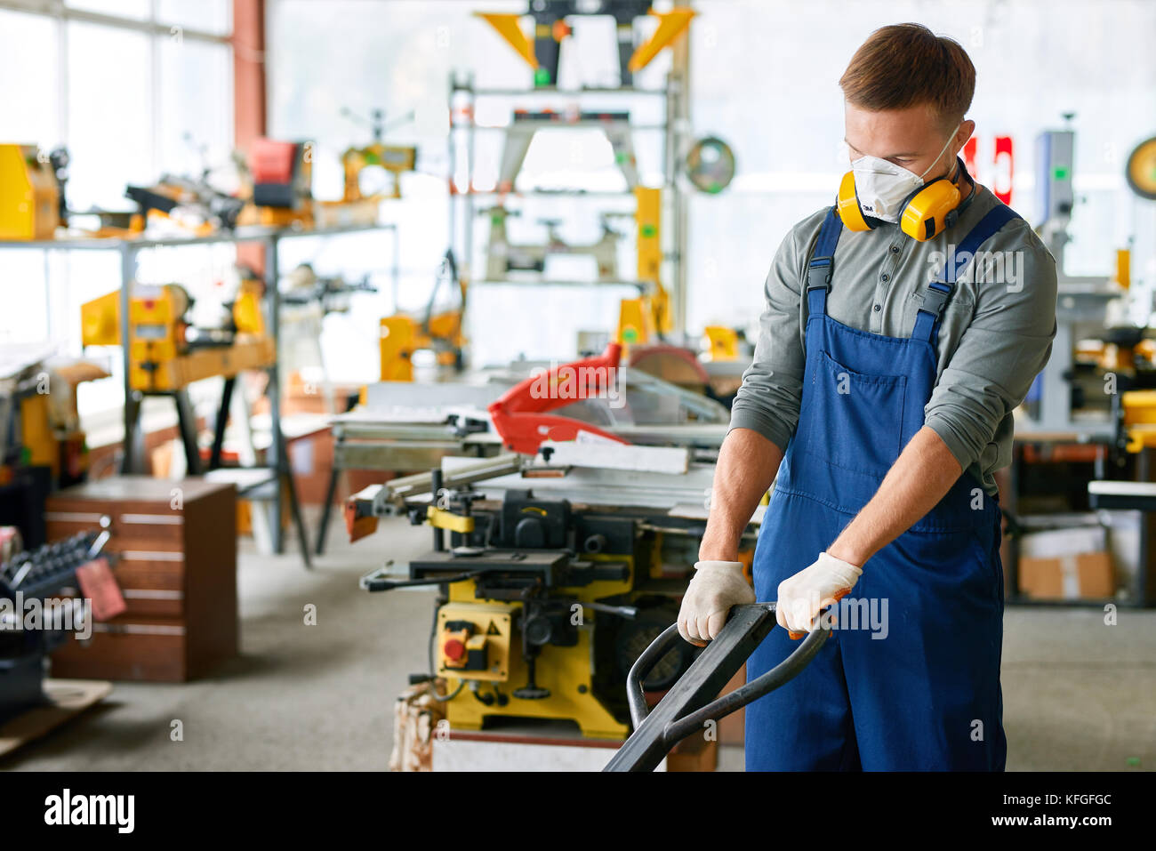 Young Man Working at Factory Stock Photo - Alamy