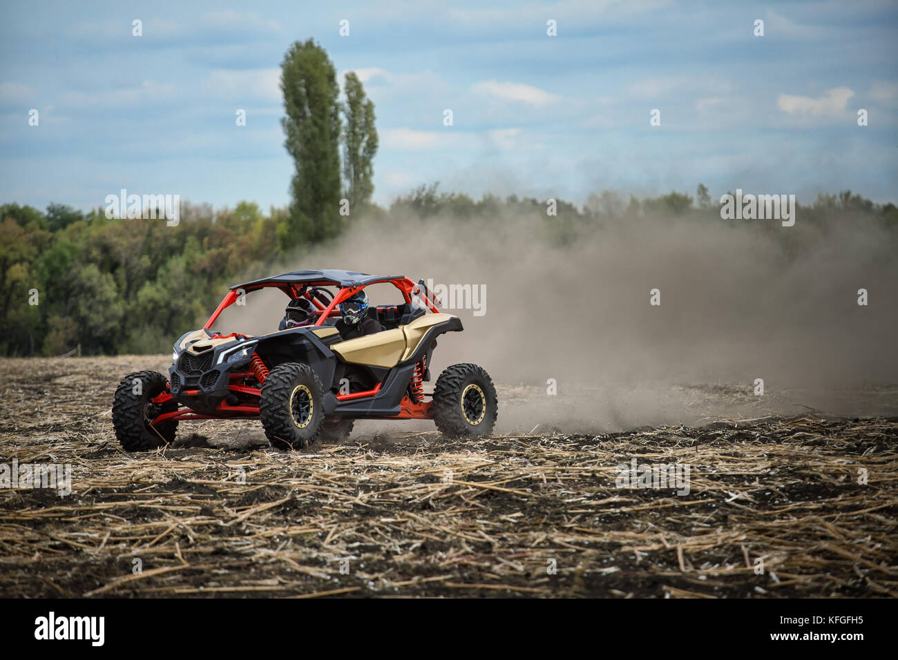 Quad bike is racing along an oblique field Stock Photo - Alamy