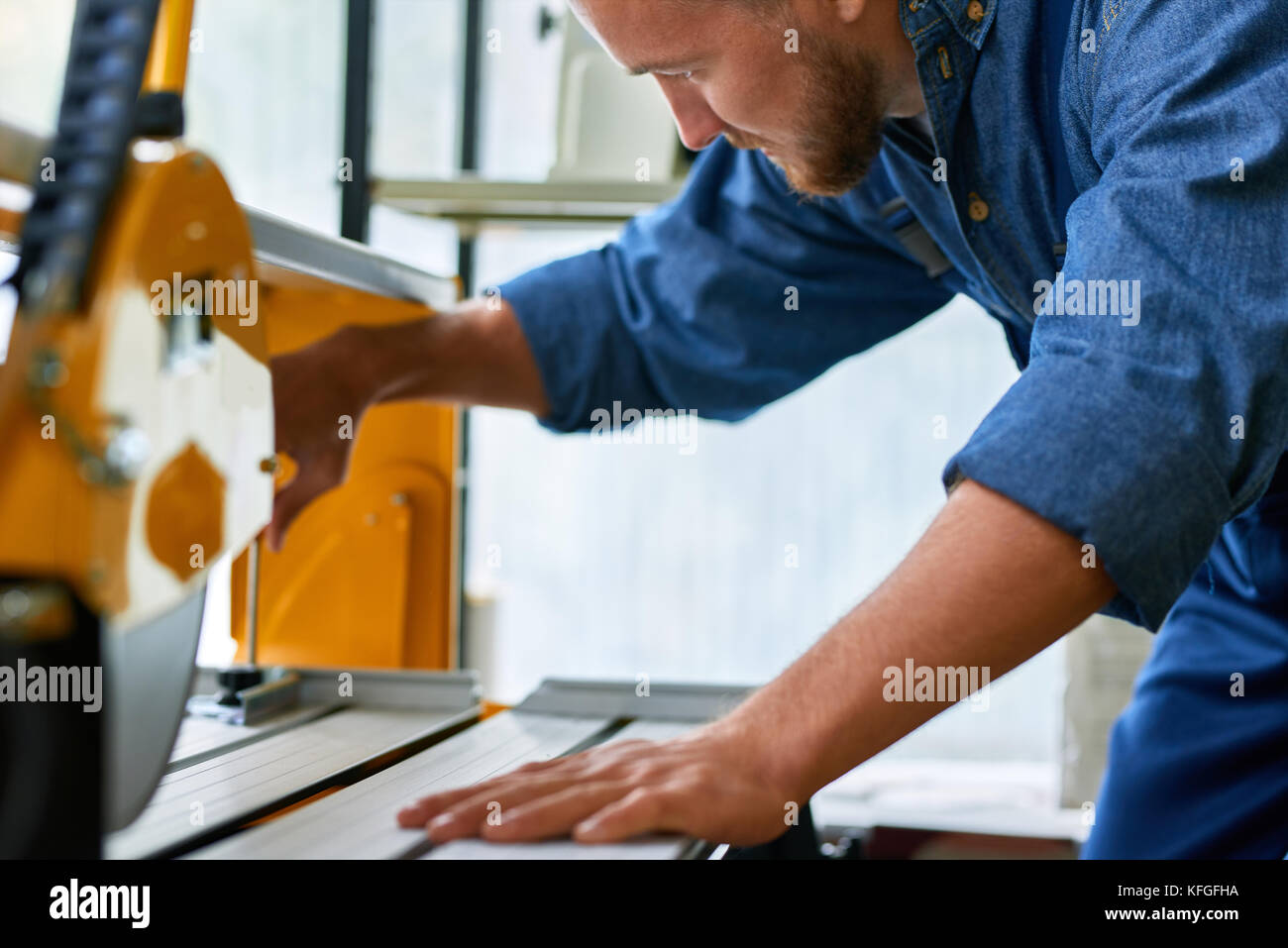 Factory Worker Using Machines Stock Photo - Alamy