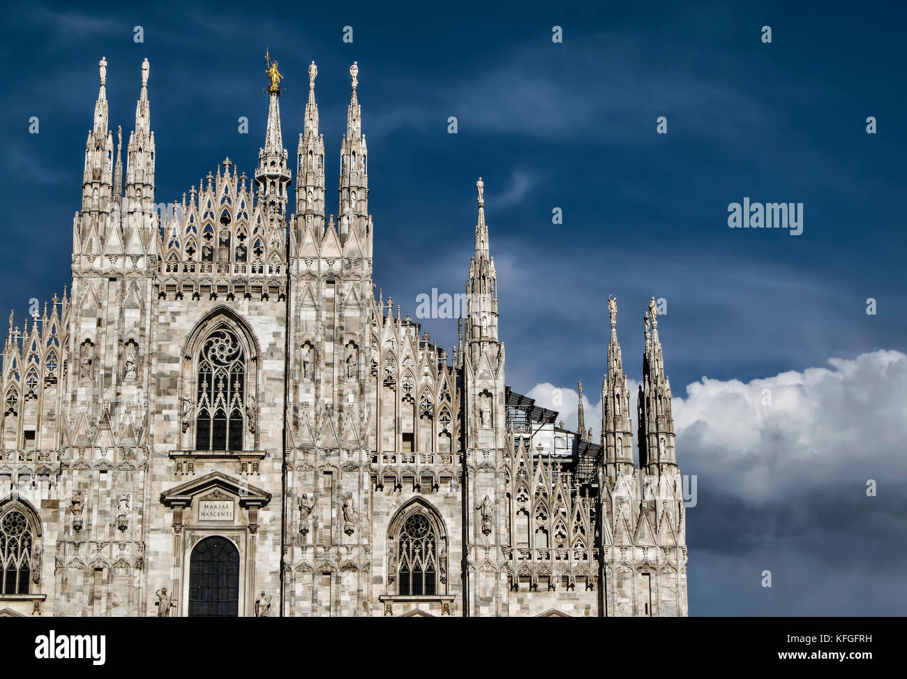 a view on Milan cathedral facade with a blue sky on background and a ...