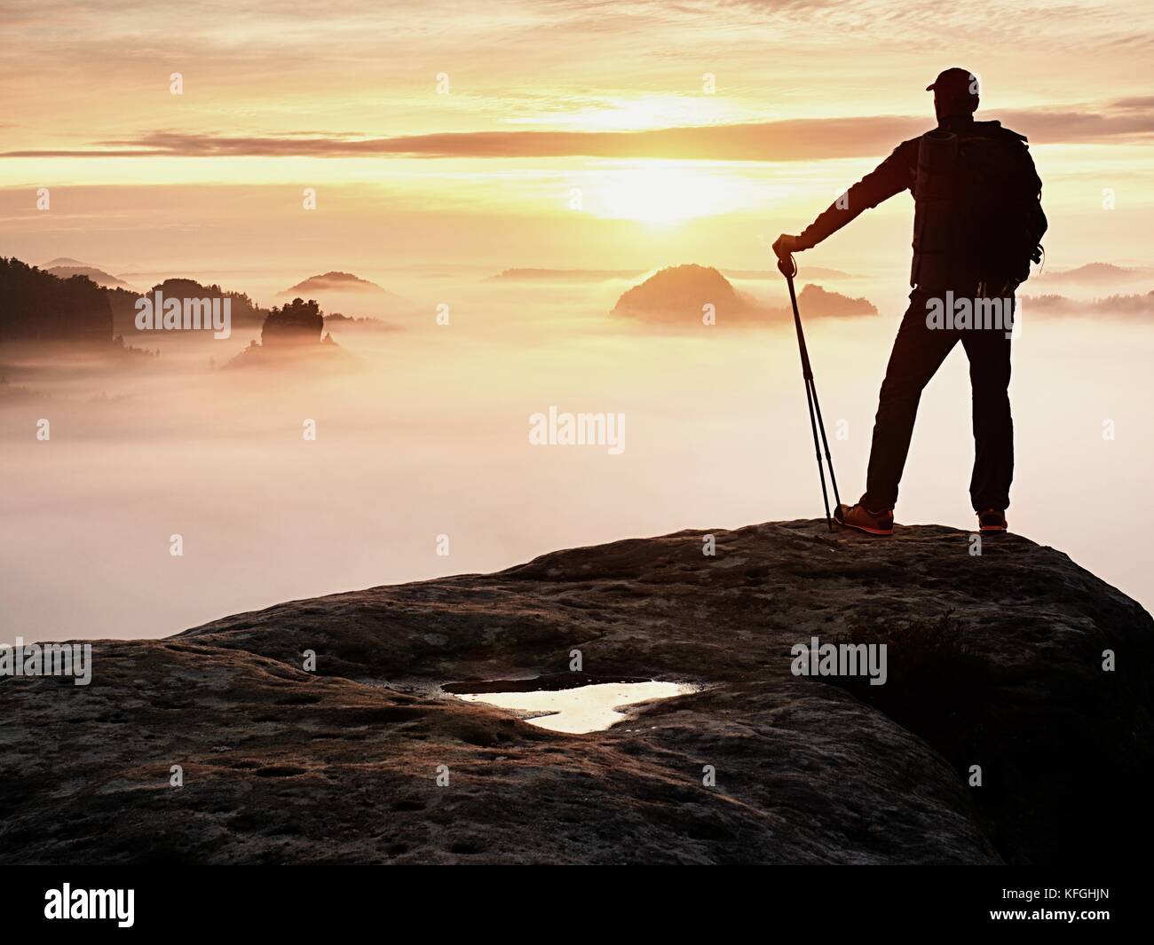 Man silhouette stay on sharp rock peak. Satisfy hiker enjoy view. Tall ...