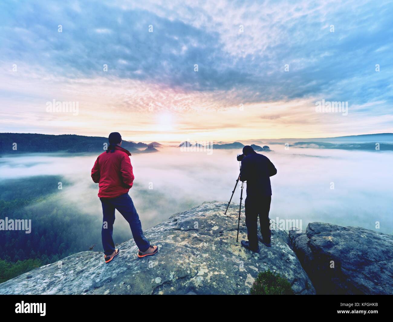 Two men enjoy photographying in wild nature. Nature photographer with ...