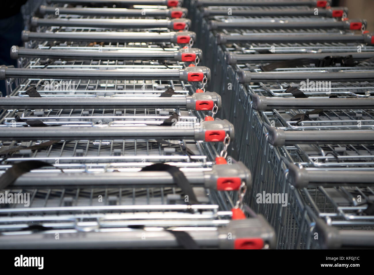 Coin operated supermarket shopping trolleys in a supermarket shop Stock ...