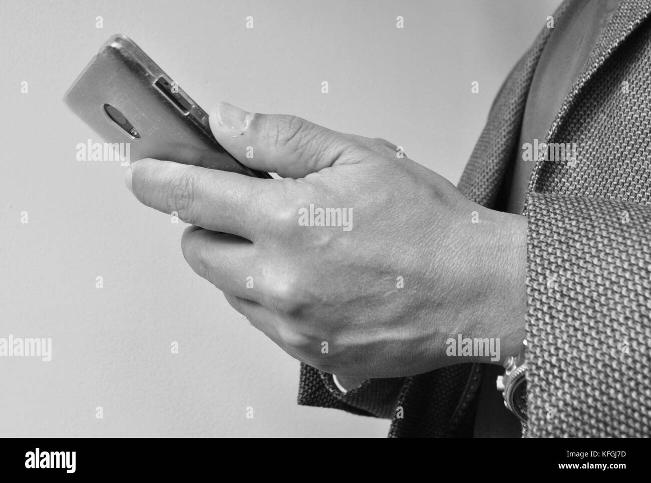 A business man holding a mobile smart phone. Close up Stock Photo - Alamy
