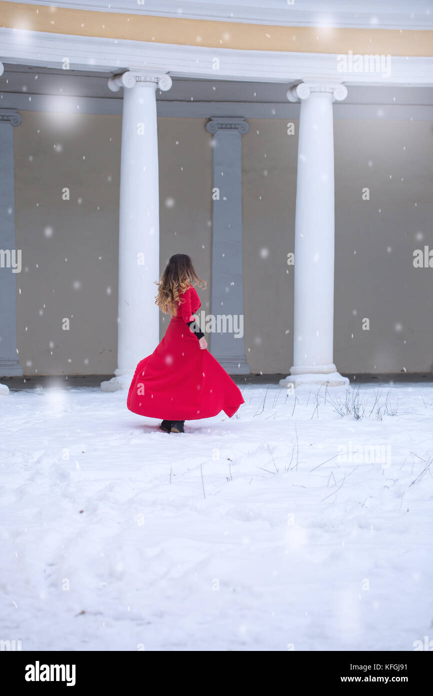 Beautiful woman in a red winter dress Stock Photo - Alamy
