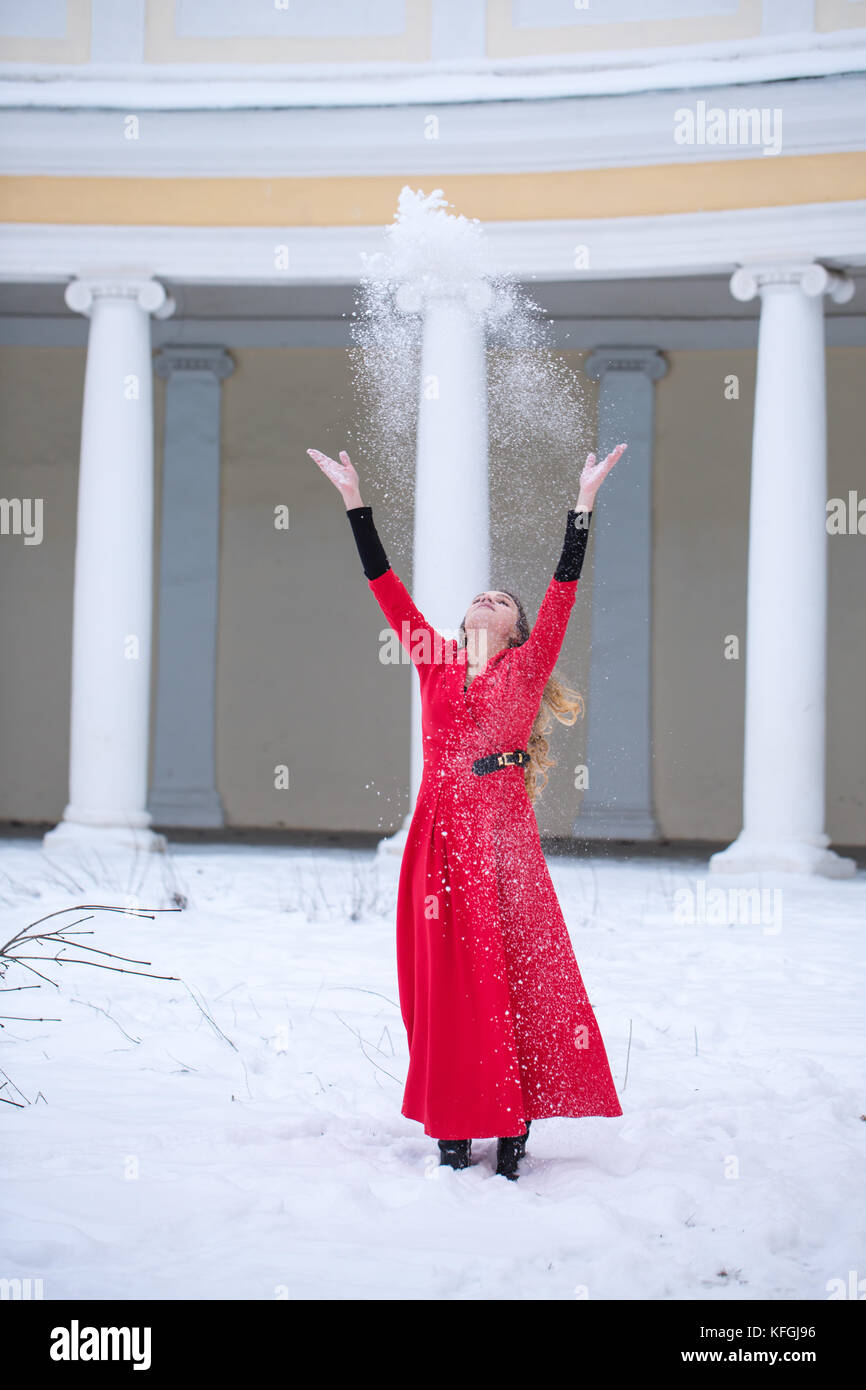 Beautiful woman in a red winter dress Stock Photo - Alamy