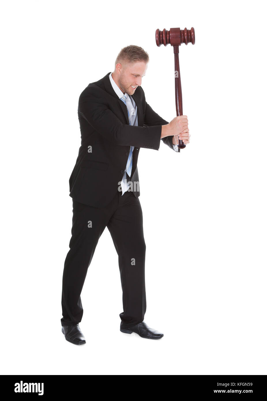 Businessman wielding a big wooden mallet holding it above his head with ...