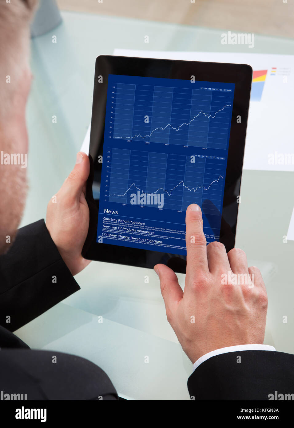 Businessman navigating on his tablet-pc using his finger on the ...