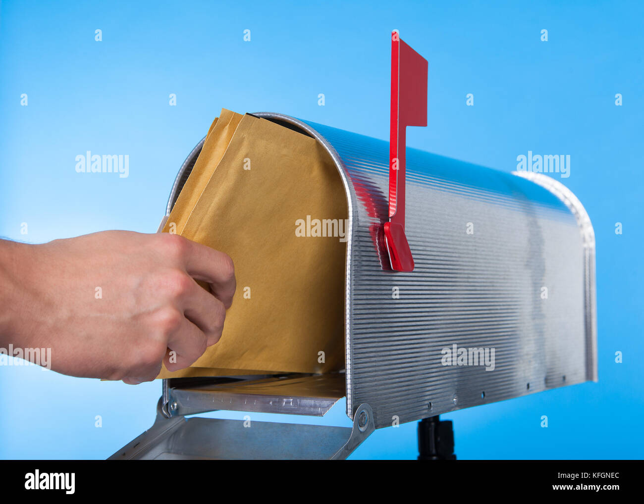 Man opening his mailbox to remove mail inside close up of his hand on ...
