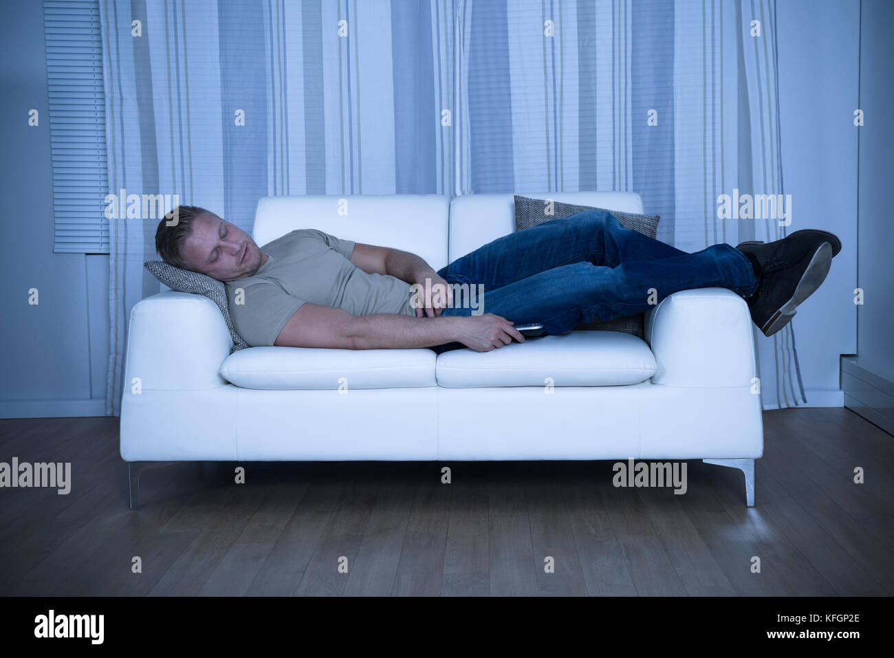 Portrait Of A Young Man Sleeping On Couch Stock Photo - Alamy