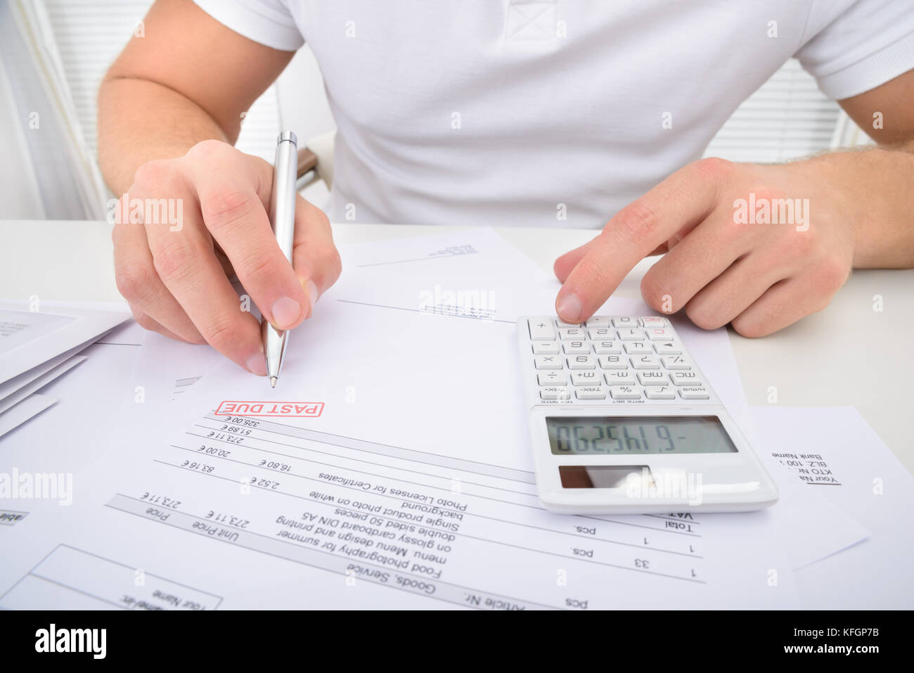 Man Calculating Past Due Statement Using Calculator Stock Photo - Alamy