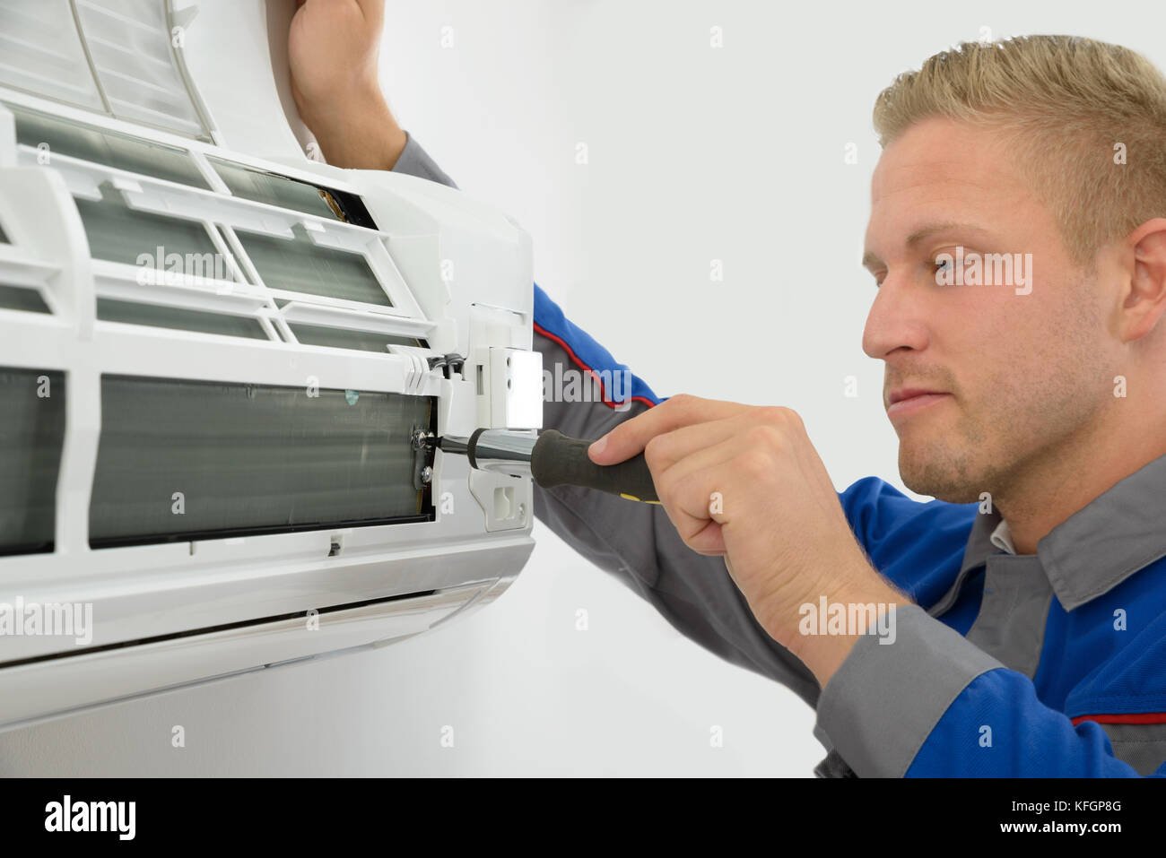 Portrait technician repairing air conditioner hi-res stock photography ...