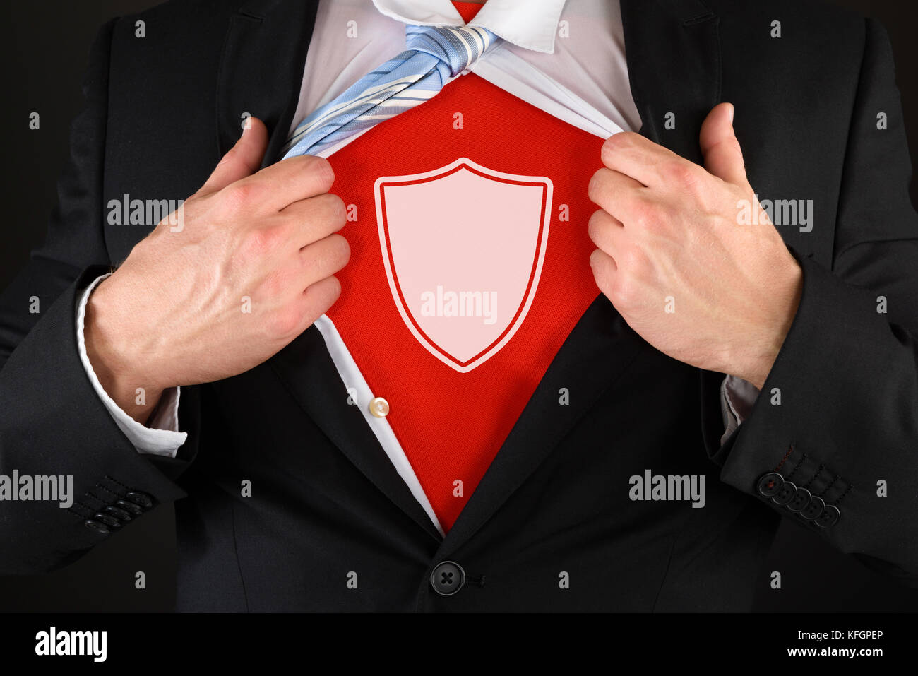 Close-up Of Businessman Pulling Shirt Showing A White Shield Symbol ...