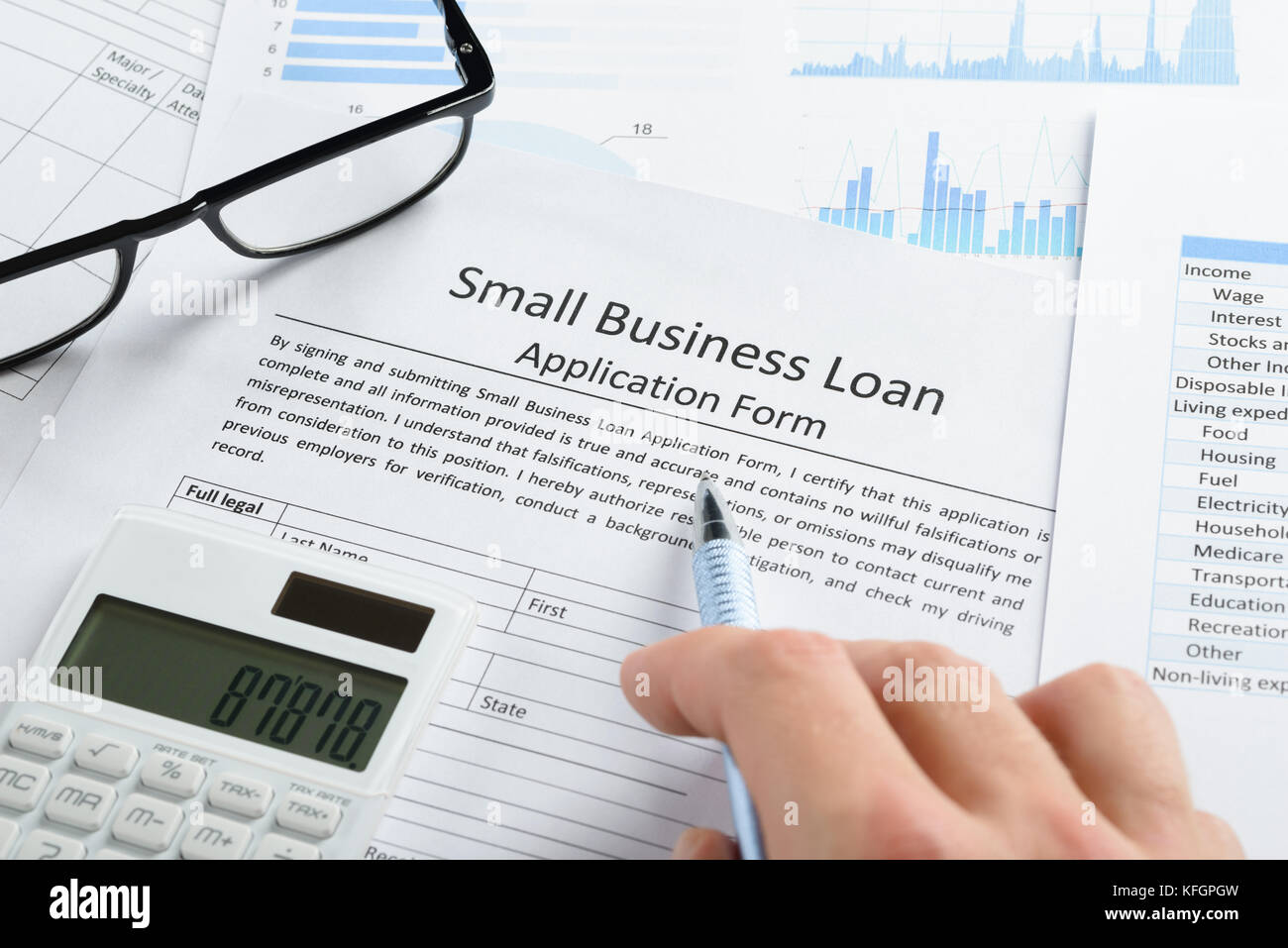 Hand With Pen And Calculator On Business Loan Application Form Stock ...