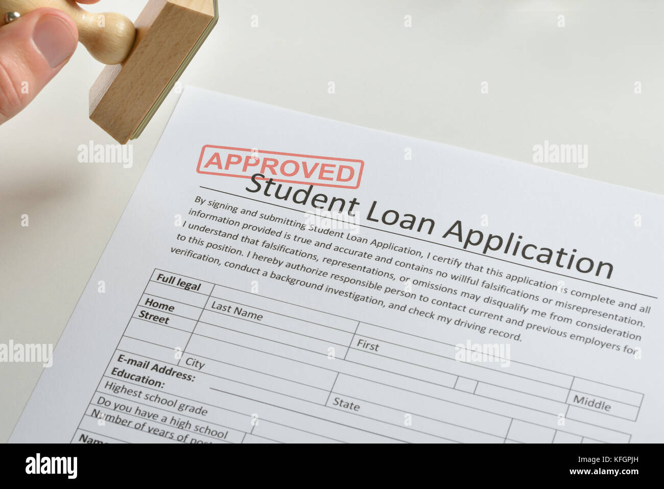 Close-up Of Person Hand With Rubber Stamp And Approved Student Loan ...