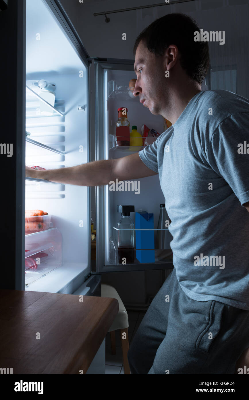 Portrait Of A Man Taking Food From Refrigerator Stock Photo - Alamy