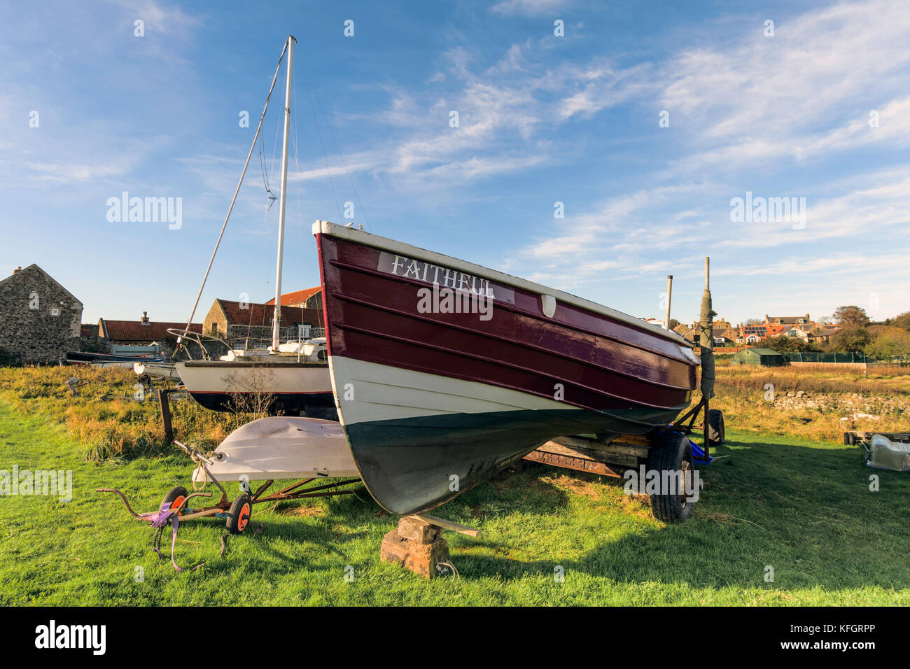 Tradditional Coble fishing boat with other boats at Holy Island ...