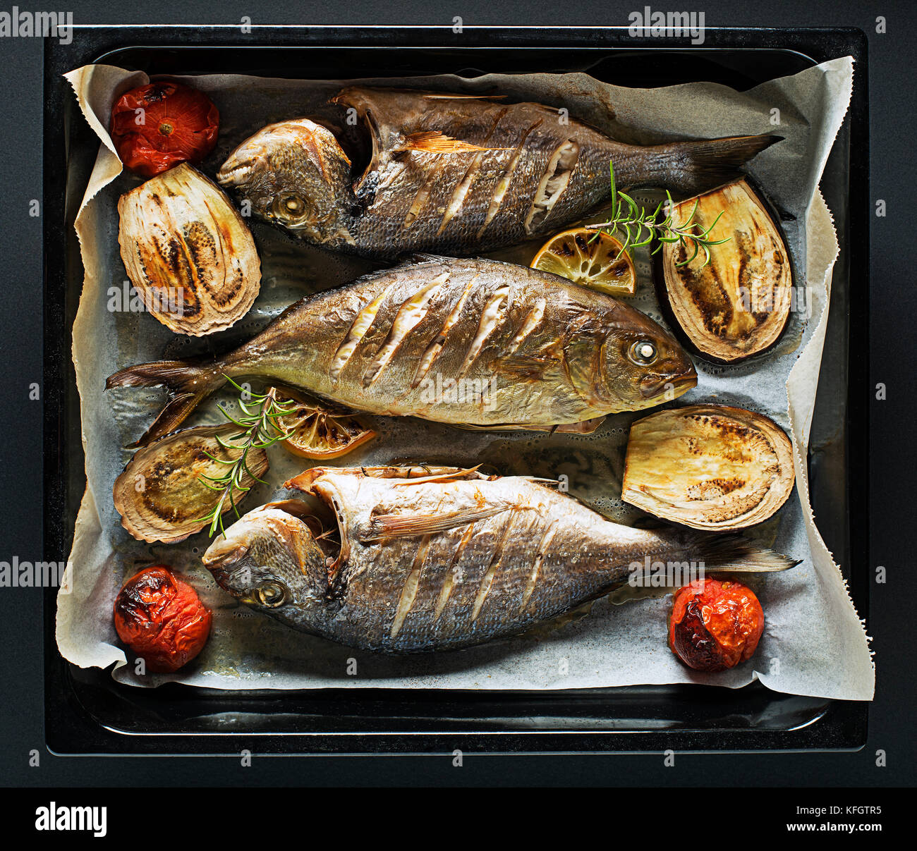 Grilled Gilt-head bream fish with lemon, herbs, oil, vegetables and ...
