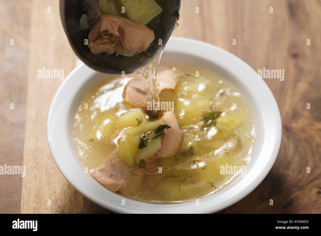 closeup pour fish soup with trout into bowl, shallow focus Stock Photo ...
