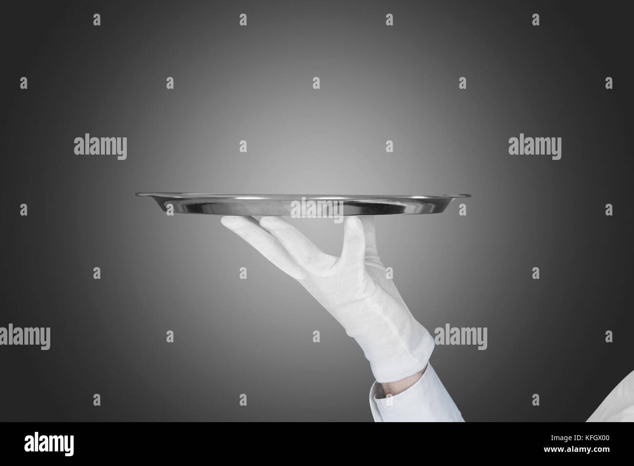 Cropped image of waiter's hand holding tray over gray background Stock ...