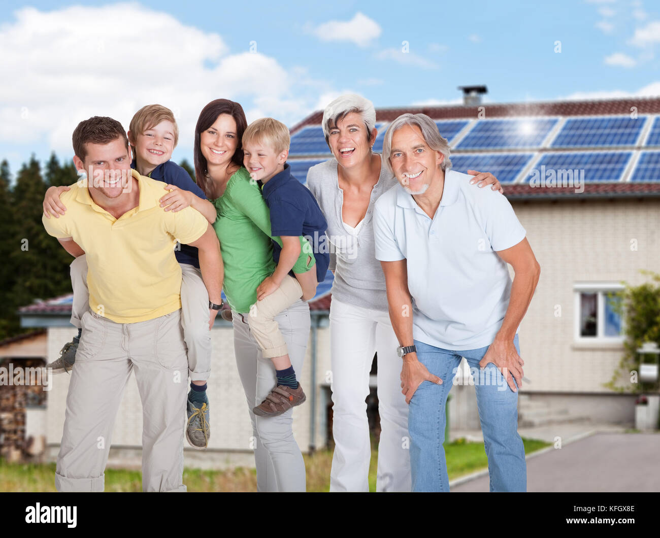 Portrait of happy multi generation family standing against home Stock ...