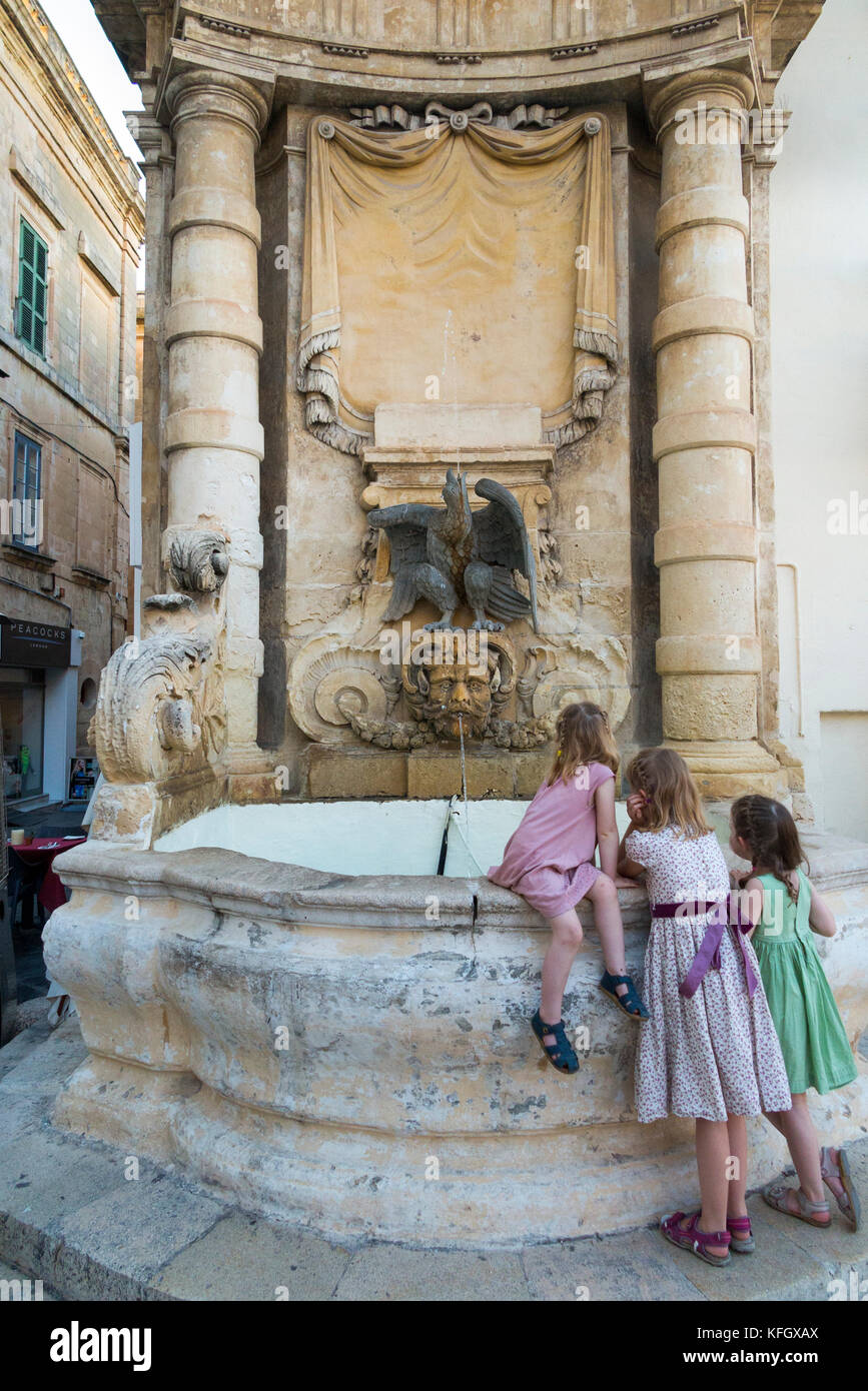 Children play around water feature / waterfall / water fountain in ...