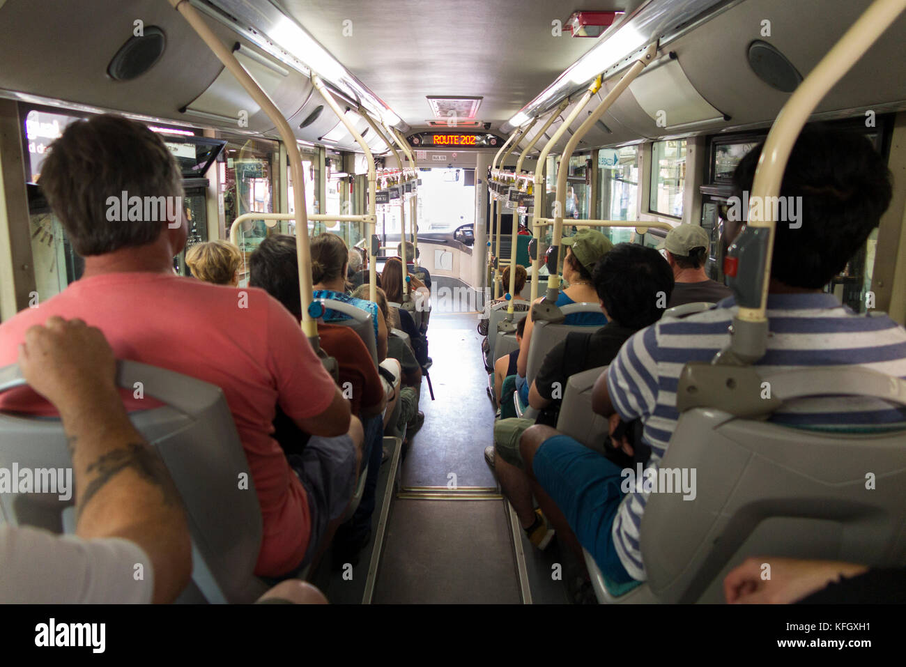 Passenger / passengers travelling on a public bus / using public ...