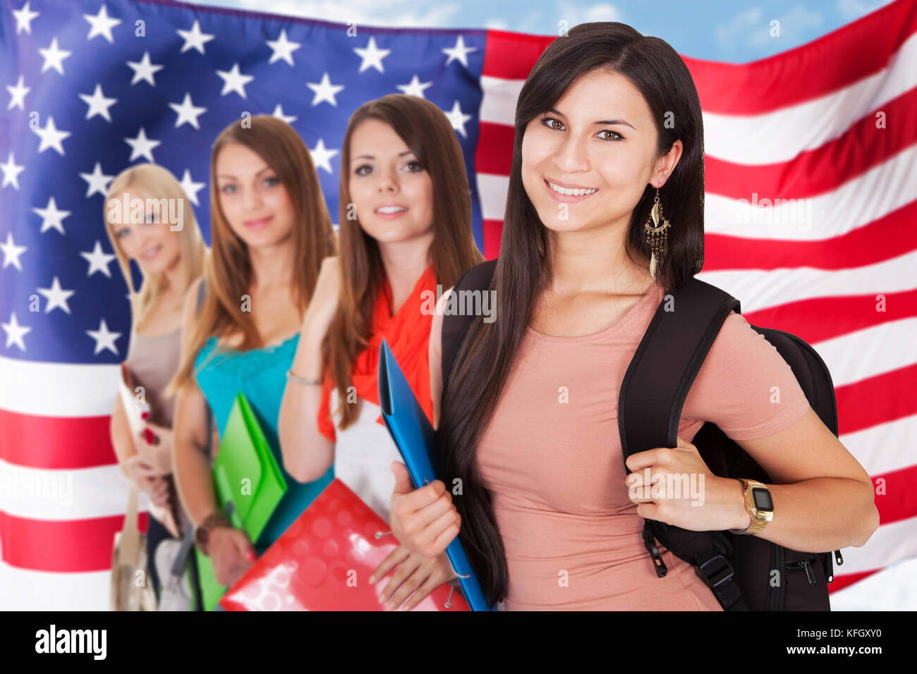 Portrait Of Young Female Students Standing In Front Of American Flag ...