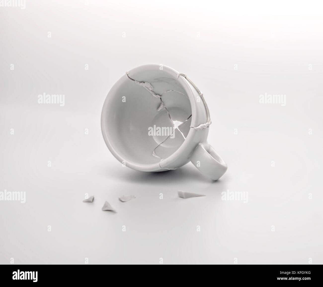 glued broken white cup laid on floor, concept disintegration Stock ...