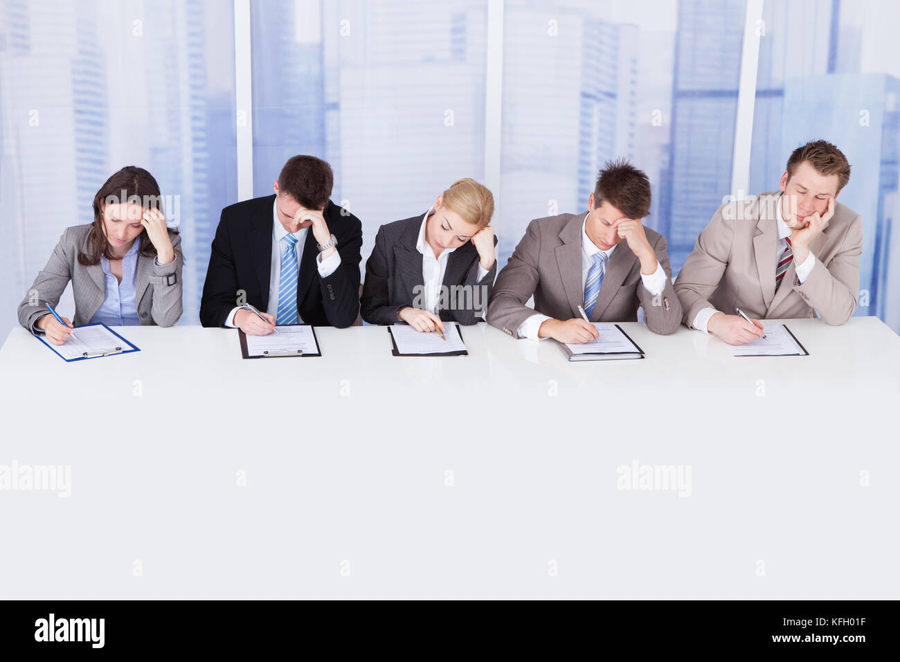 Group of tired corporate personnel officers at table in office Stock ...