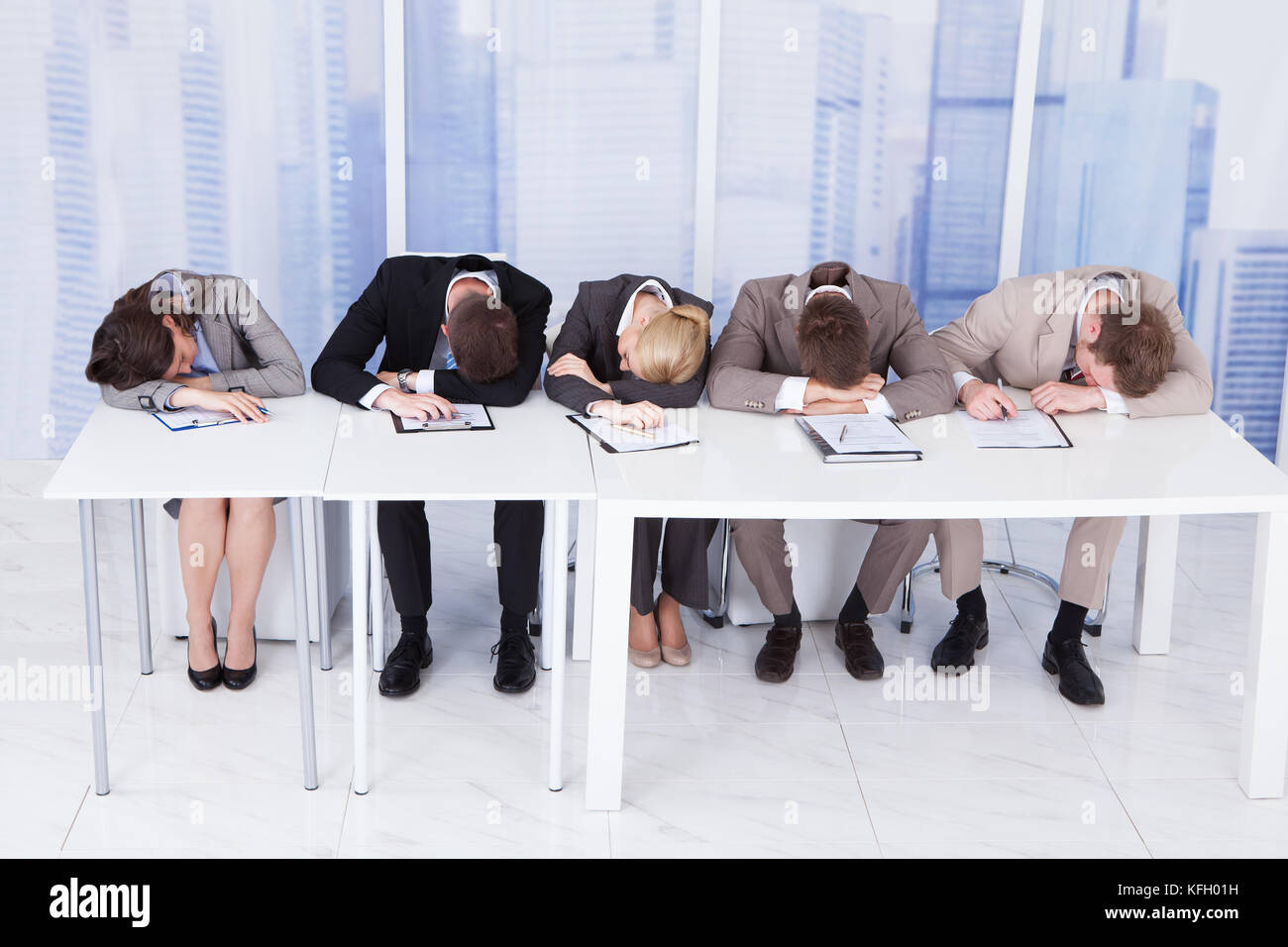 Group of tired corporate personnel officers sleeping at table in office ...