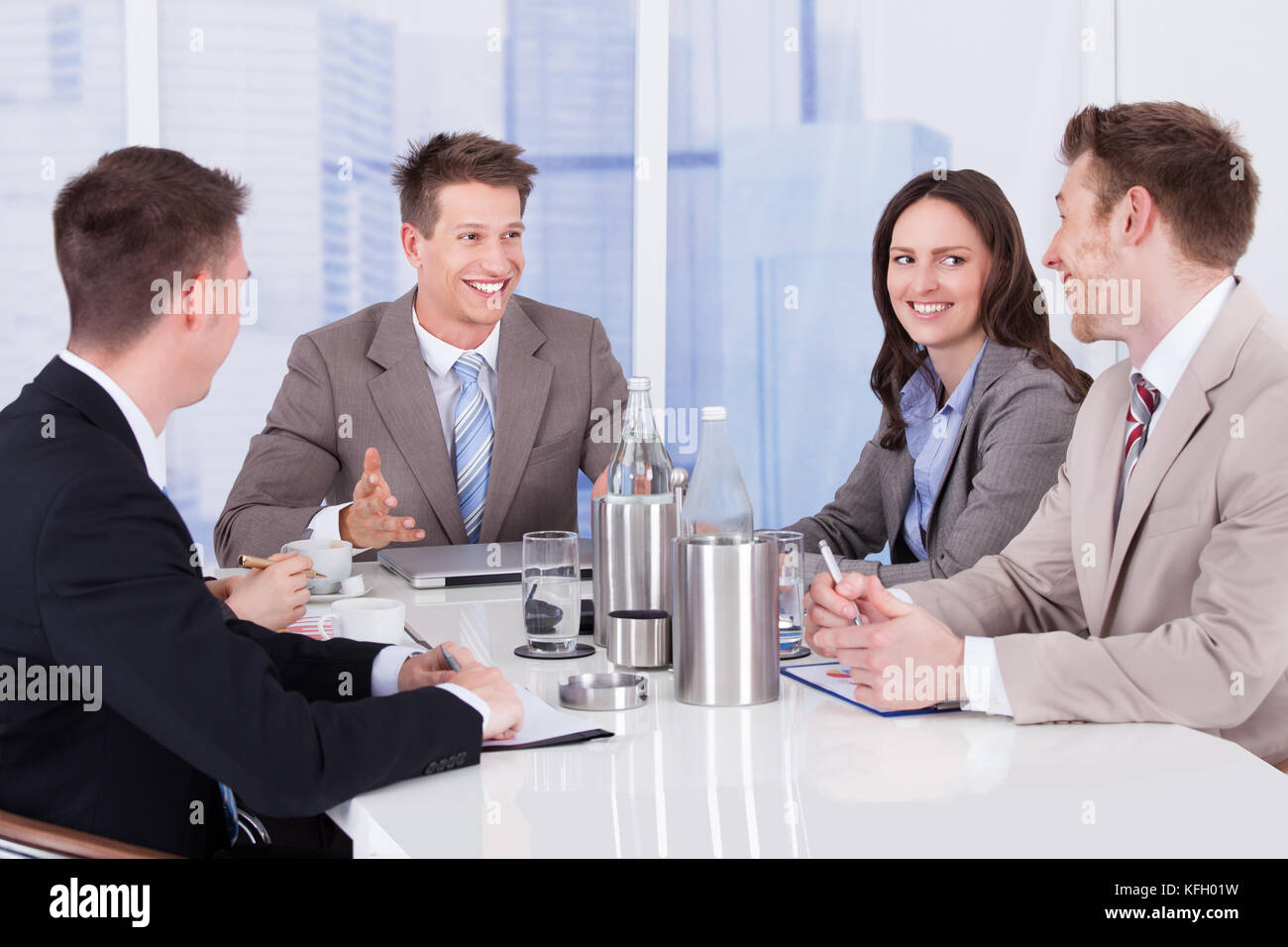 Group of young business people discussing at conference table Stock ...