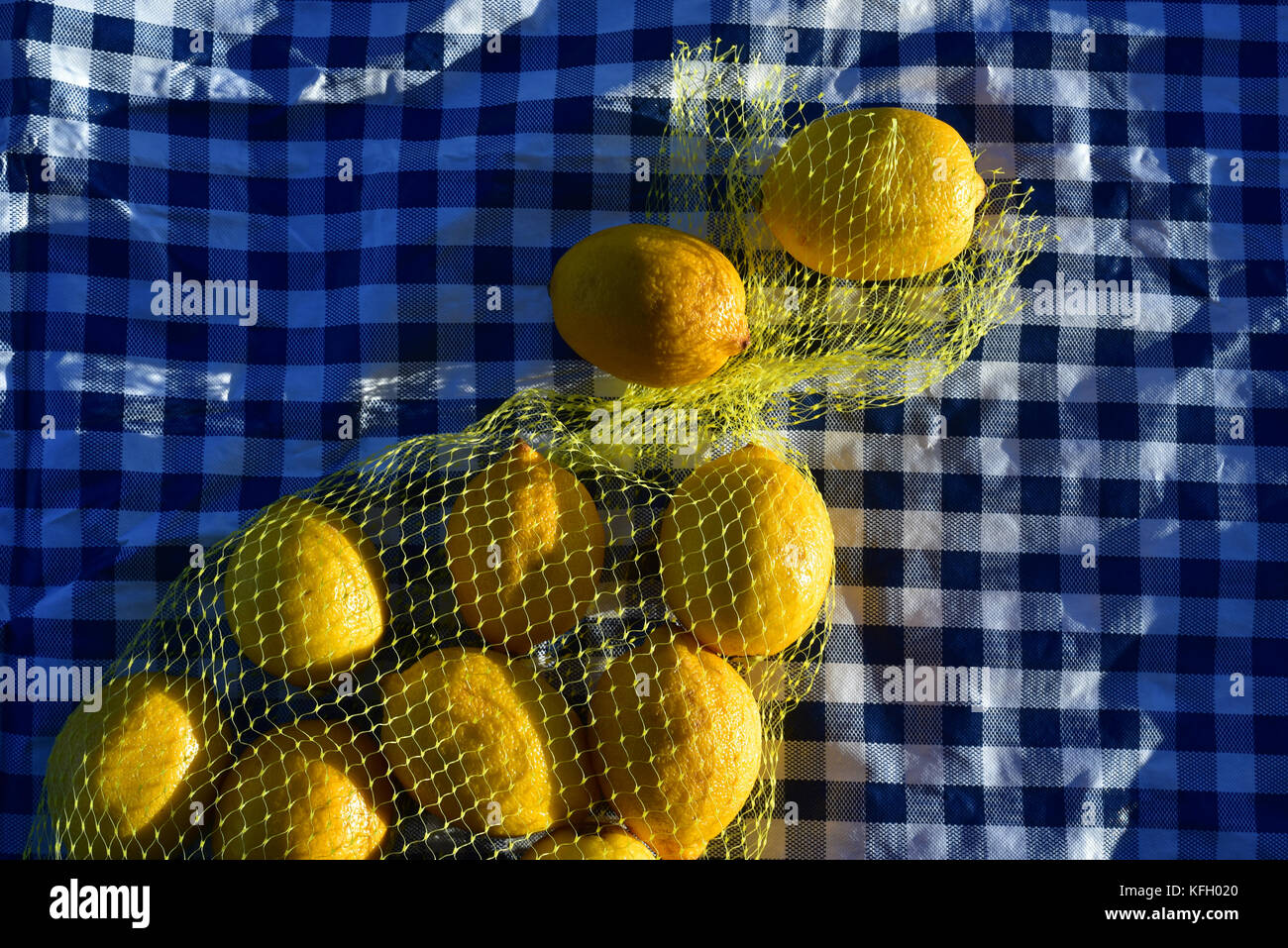 yellow net bag of yellow lemons Stock Photo - Alamy