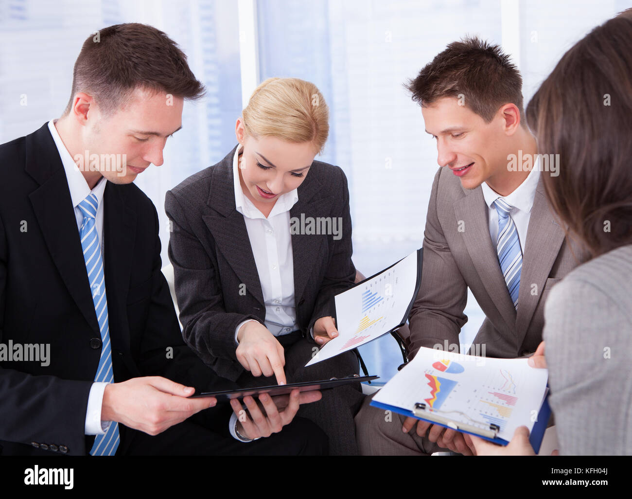 Group of young business people discussing in office Stock Photo - Alamy