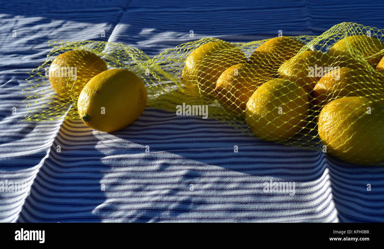 yellow net bag of yellow lemons Stock Photo - Alamy