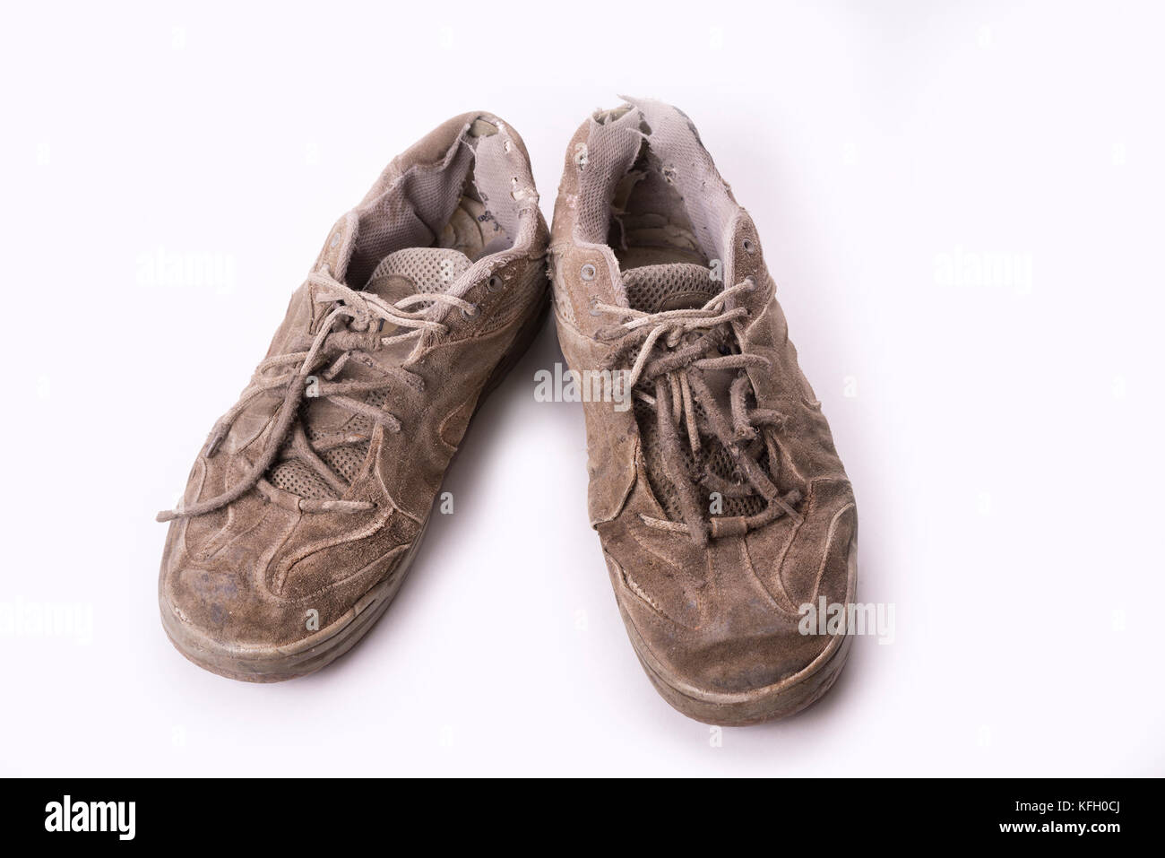 Old wear out tennis shoes isolated on white background Stock Photo - Alamy
