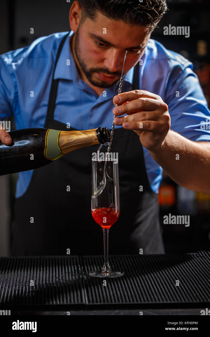 Bartender preparing a champagne cocktail with rose jam Stock Photo - Alamy