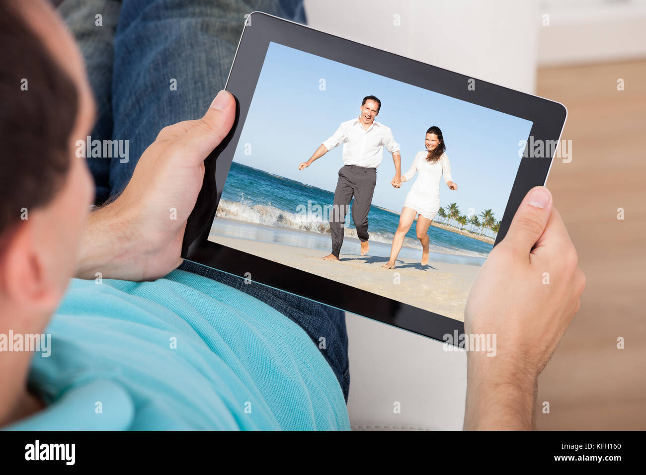 Cropped image of man watching movie on digital tablet at home Stock ...