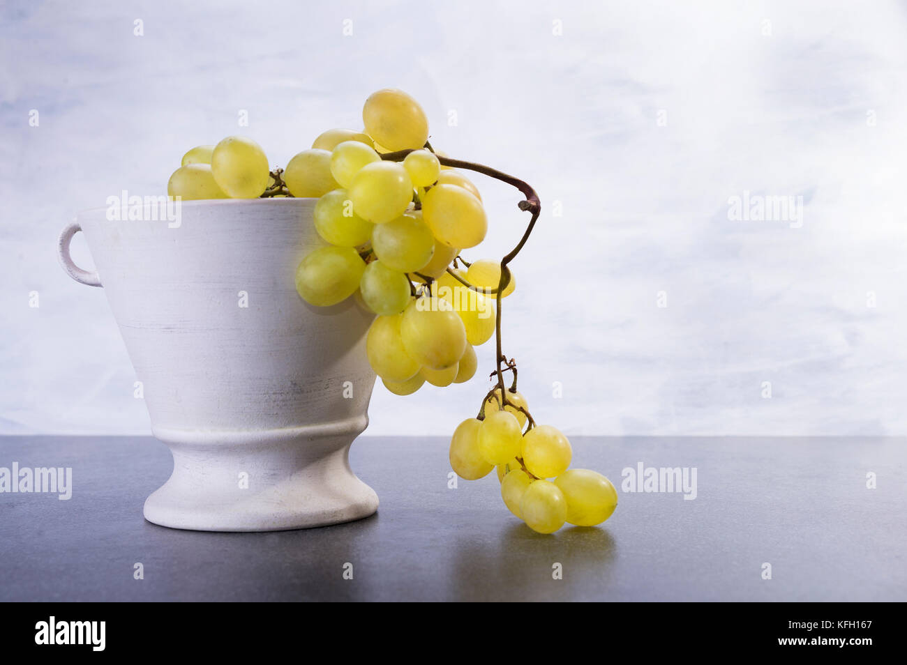 Fruit grapes in the ceramic pot on the table Stock Photo - Alamy