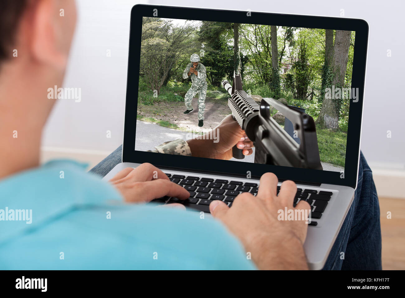 Closeup of man playing action game on laptop at home Stock Photo - Alamy